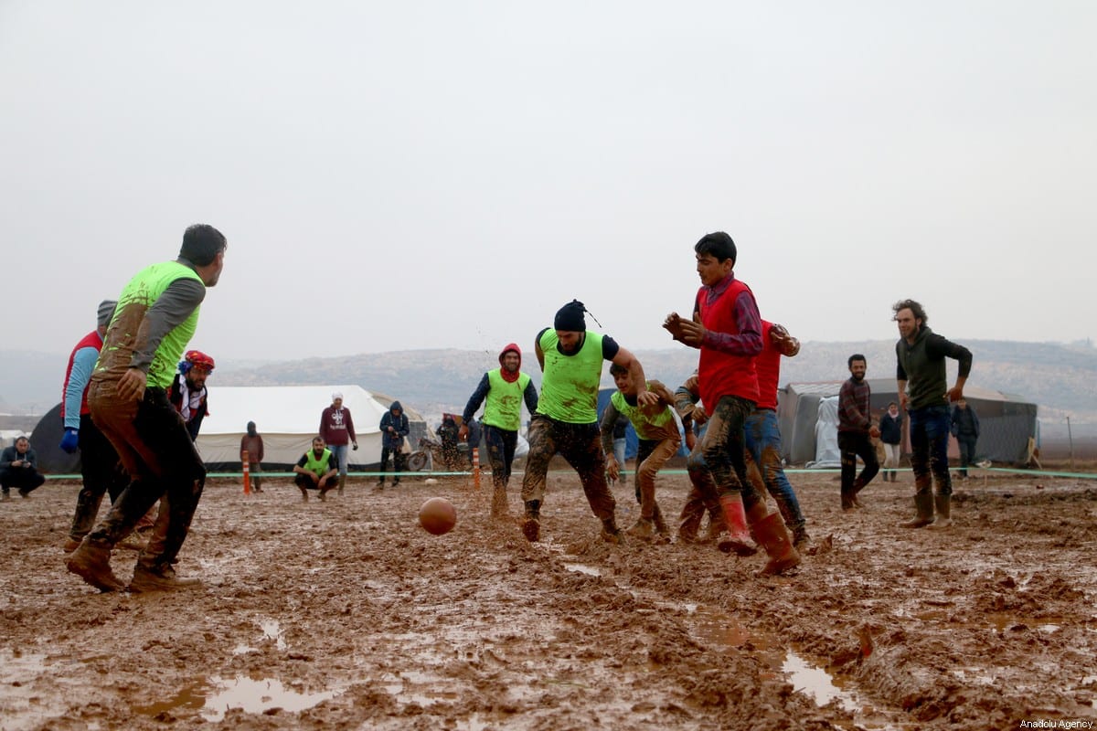 Syrian children play football on muddy ground in Idlib – Middle East ...