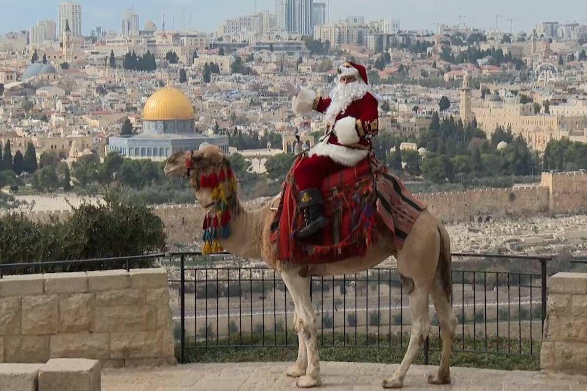 Palestinian Santa Claus rides camel into Jerusalem – Middle East Monitor