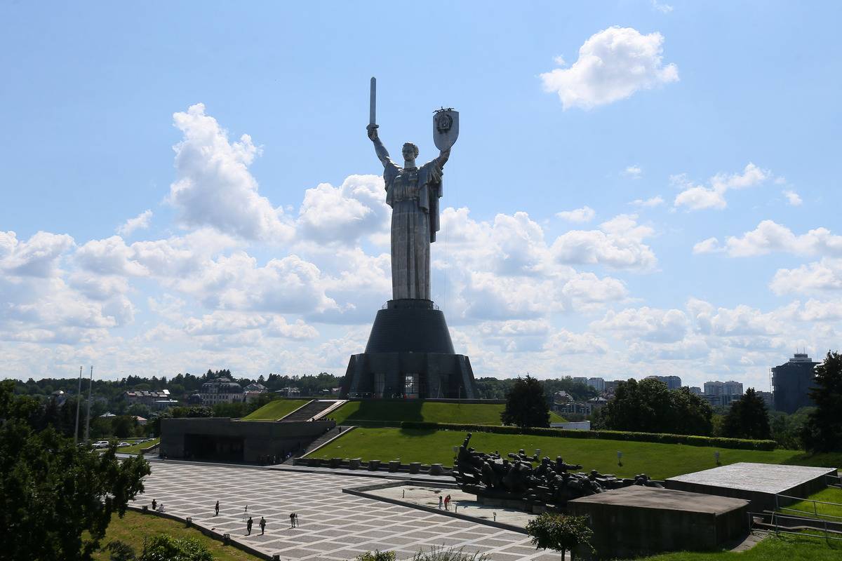Workers remove the Soviet coat of arms from the shield of the ...