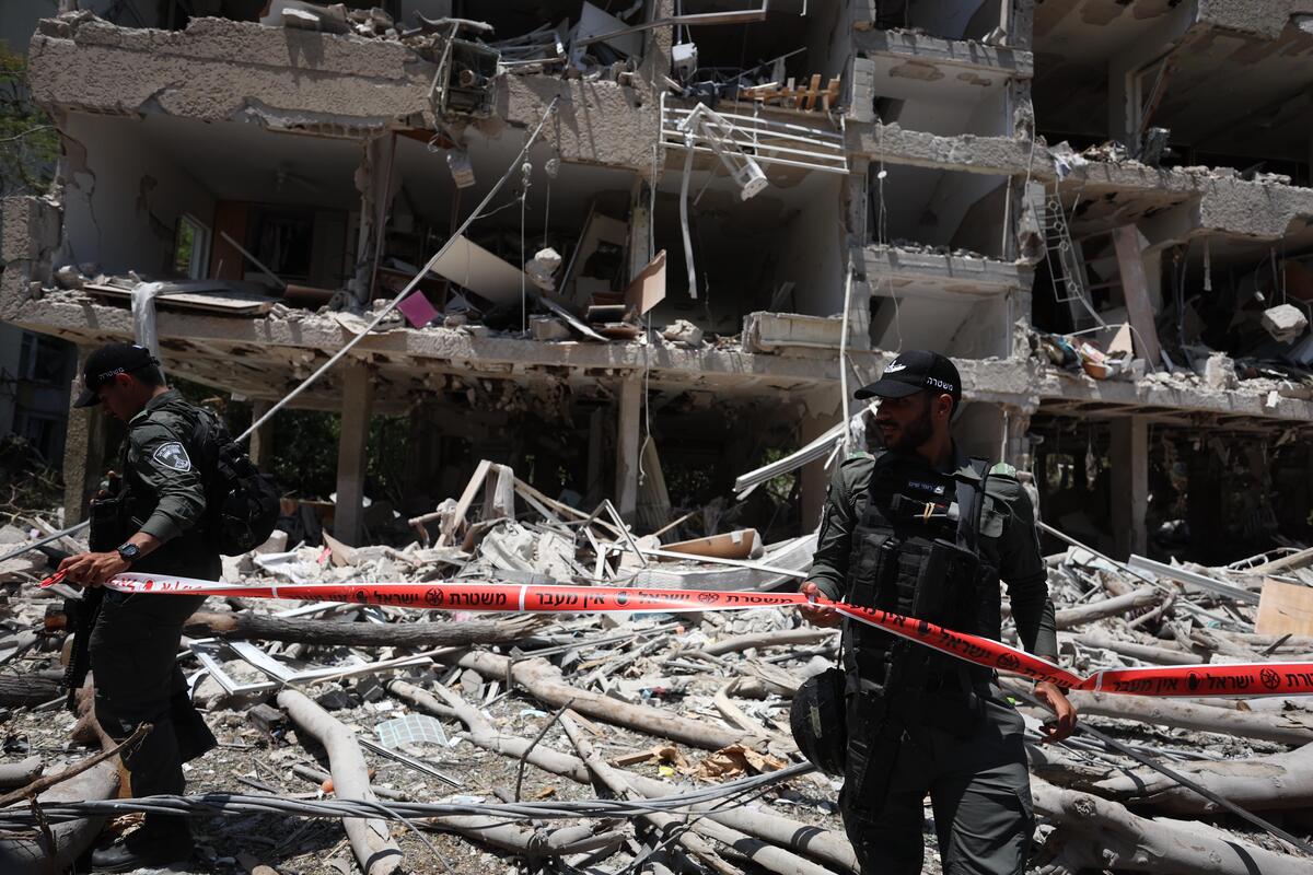 Israeli police and rescue teams respond to missile strike in Tel Aviv ...